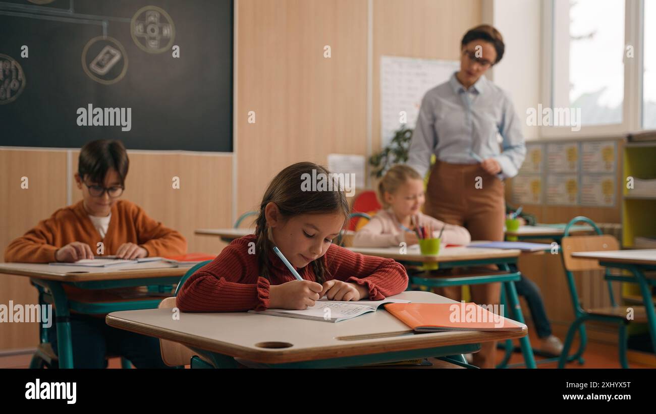 School class lesson children studying learning in classroom woman ...