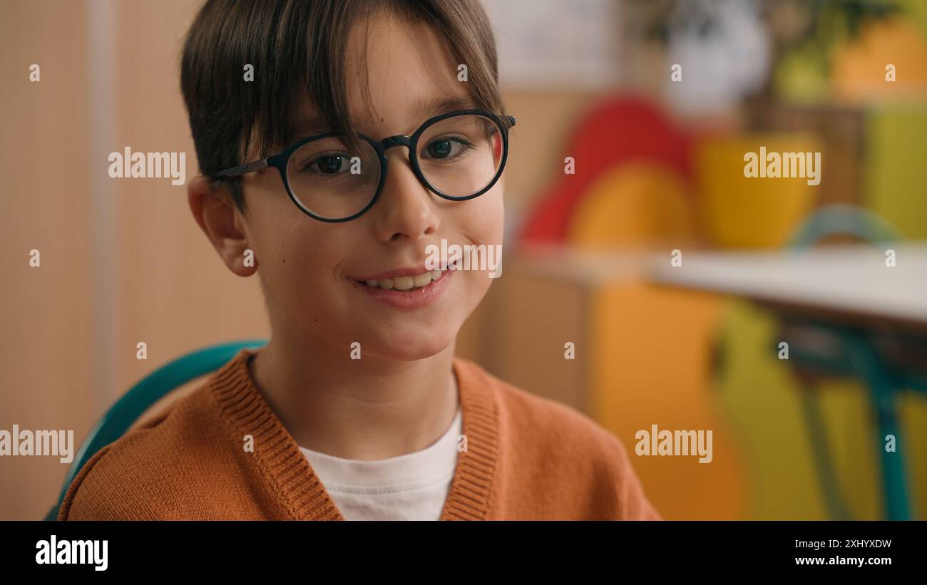 Portrait headshot little Caucasian boy in eyeglasses bad vision health ...