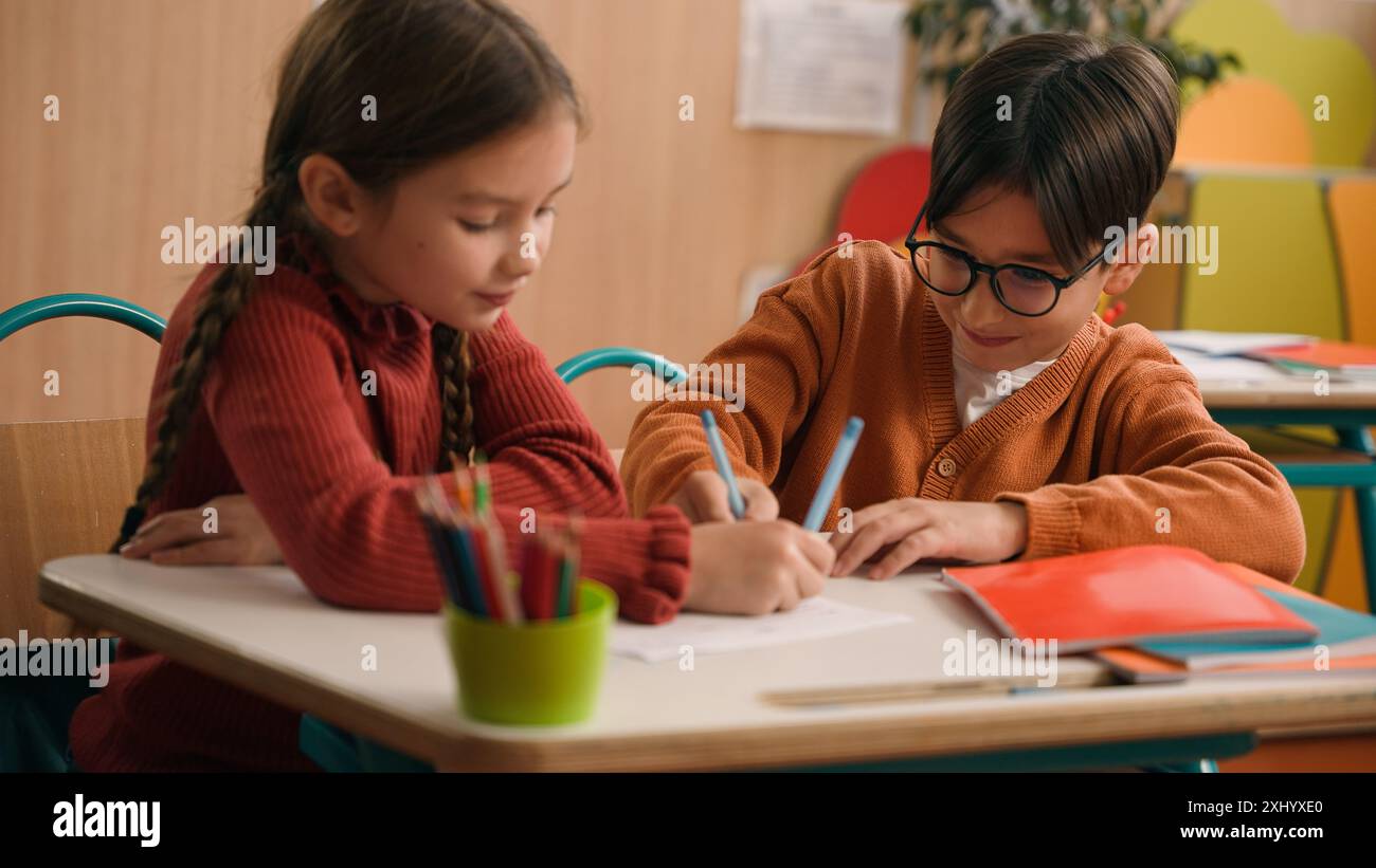 School education studying two funny playing Caucasian little girl ...