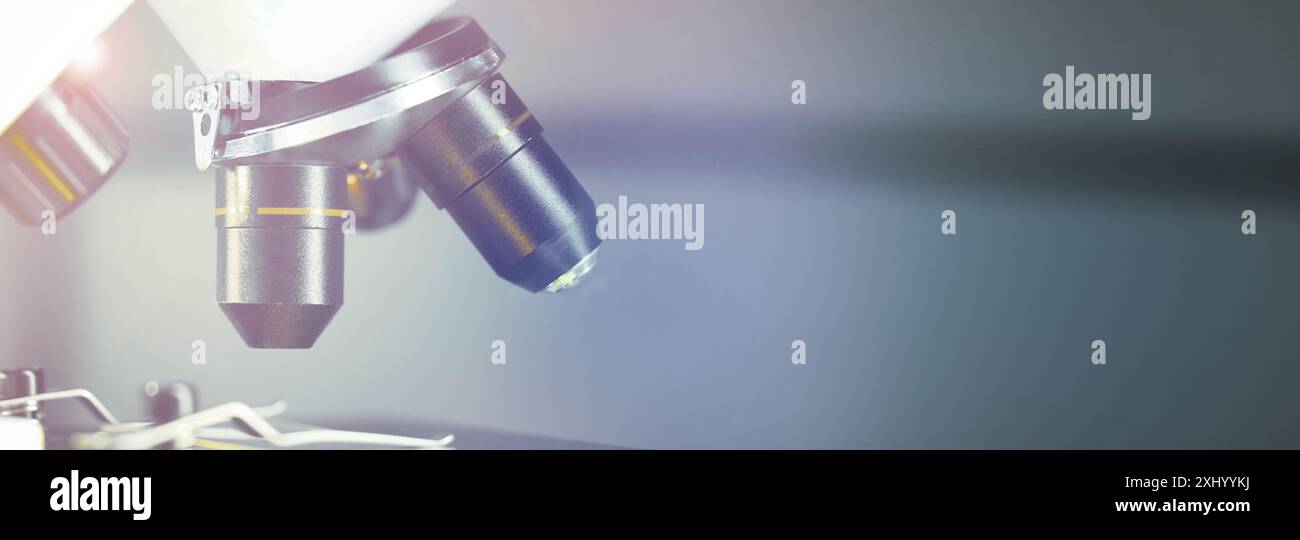 Microscope on blurred background, closeup. Banner design with space for ...
