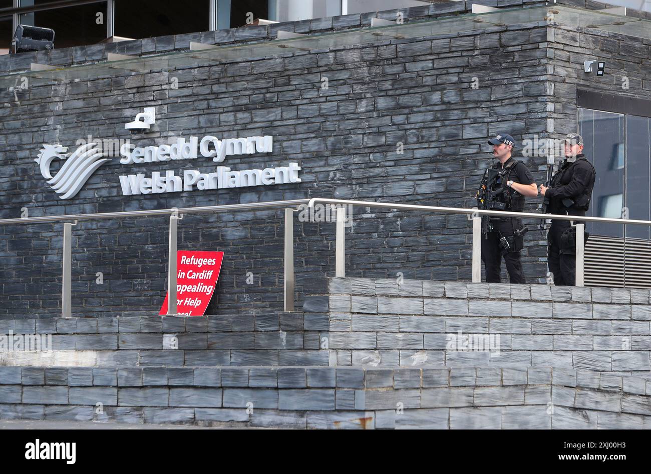 Armed police officers outside the Senedd, the Welsh parliament building ...