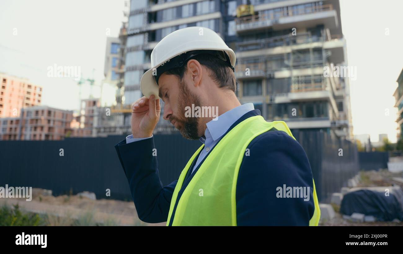 Thoughtful Caucasian pensive man inspecting controlling check building ...