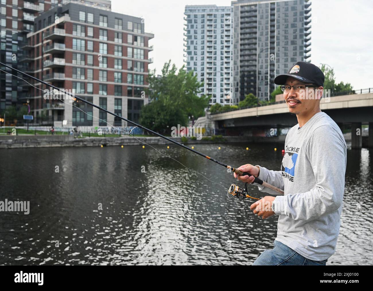 Fisherman Henry Leung casts his line on the Lachine Canal in Montreal ...