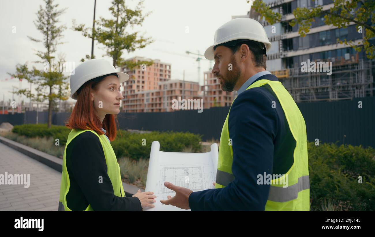 Two contractors civil engineers checking information in blueprint ...