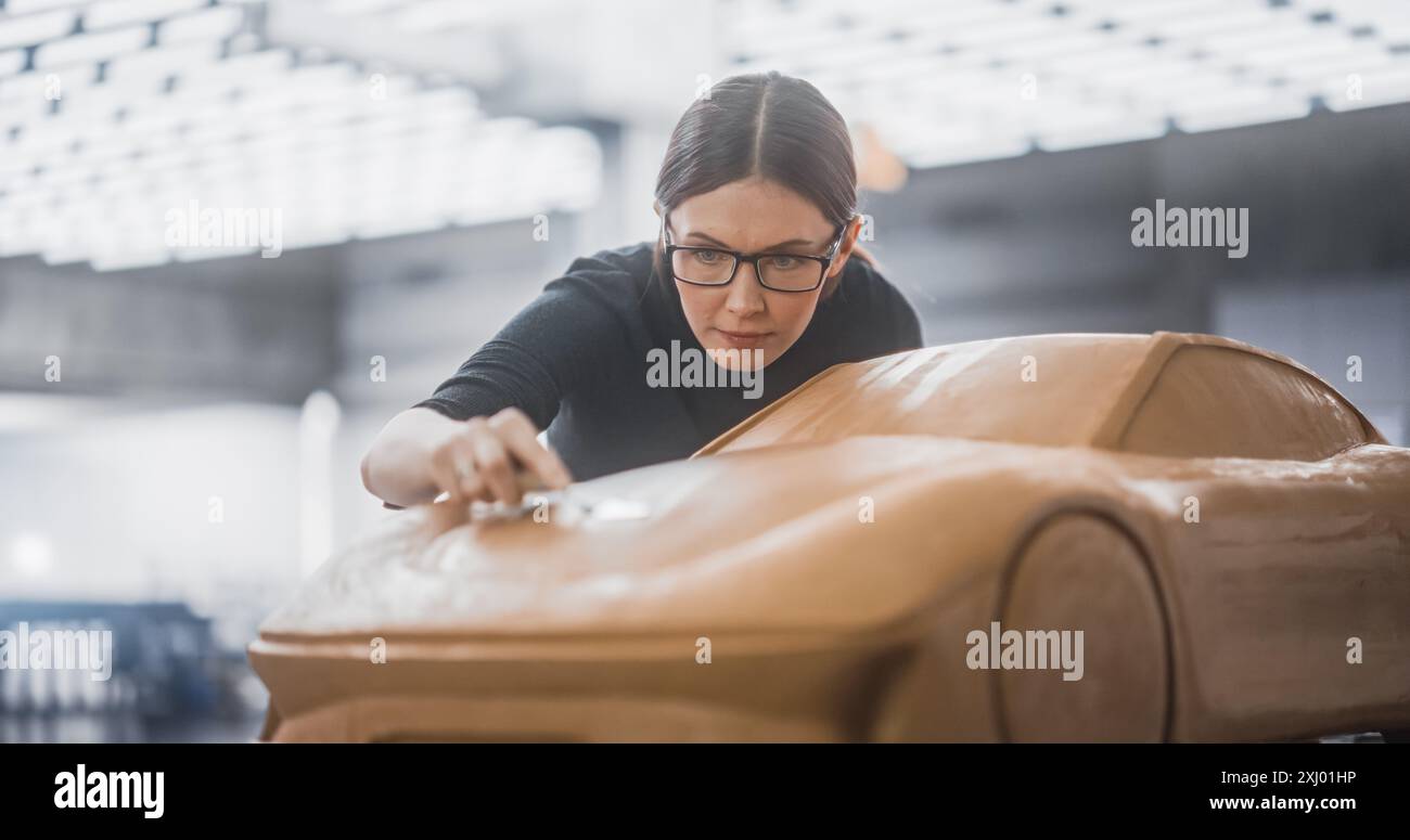 Portrait of a Female Automotive Designer Sculpting a 3D Clay Model of a ...