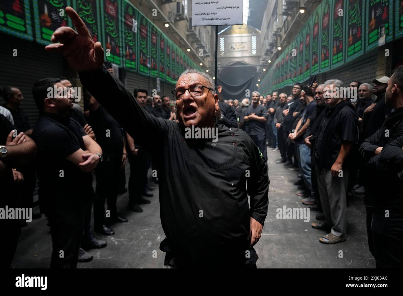 Iranian Shiite Muslims mourn during Ashoura ritual, commemorating the ...