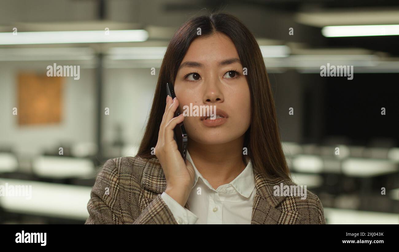 Serious calm upset tired Asian woman business talk call Japanese ...