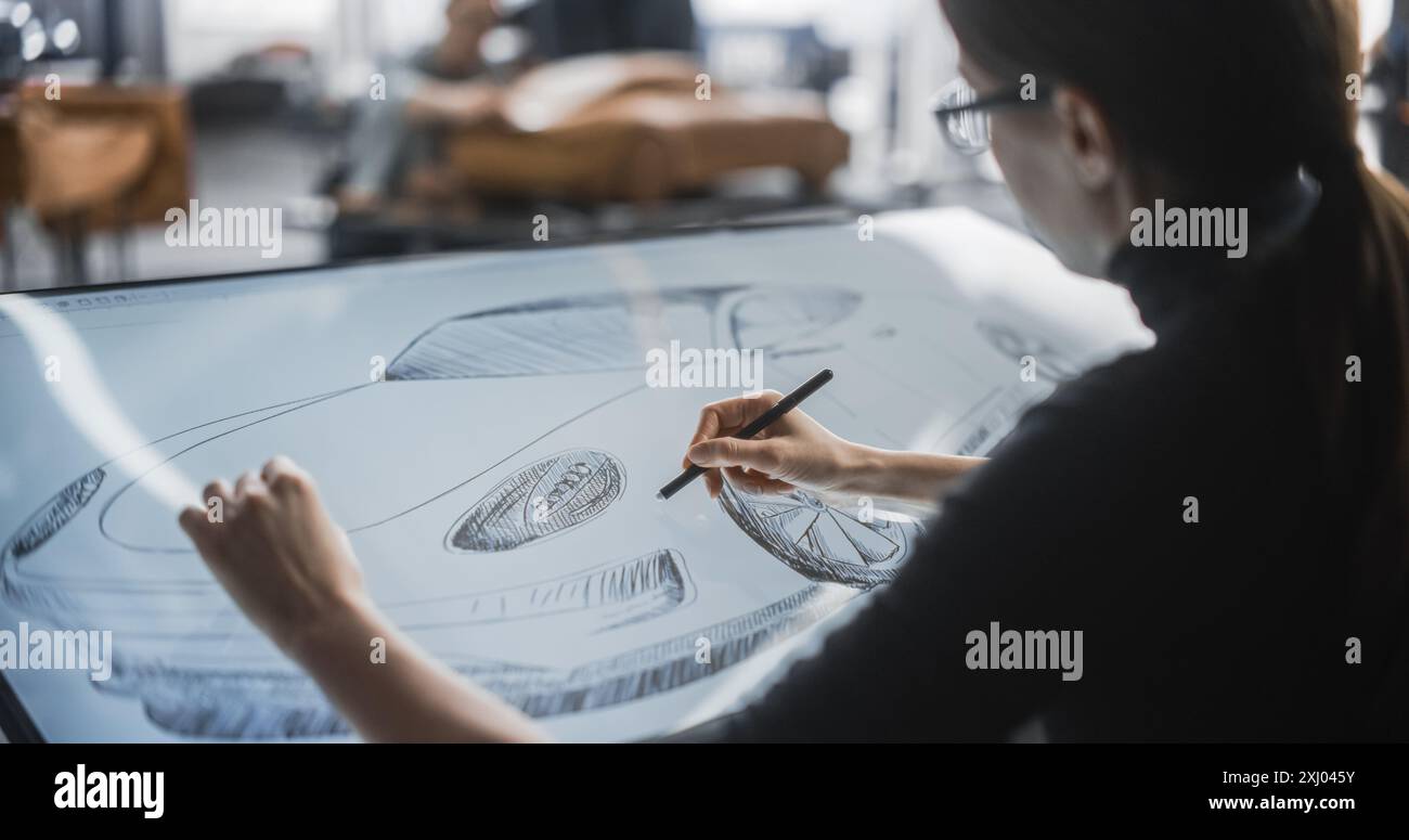Female Automotive Designer Using a Digital Tablet to Draw a Prototype ...