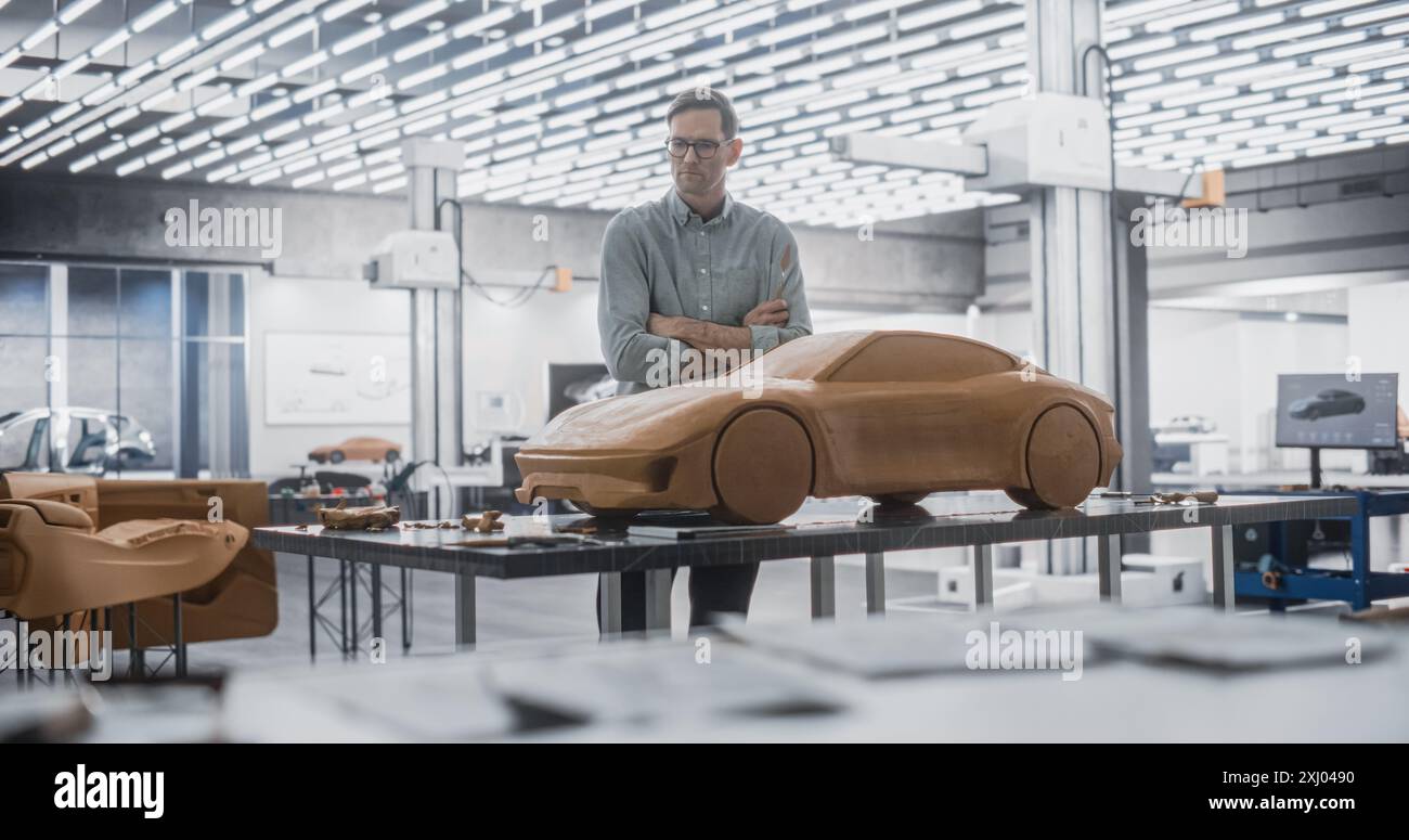 Automotive Designer Using a Spatula to Create a Prototype Car Out of ...