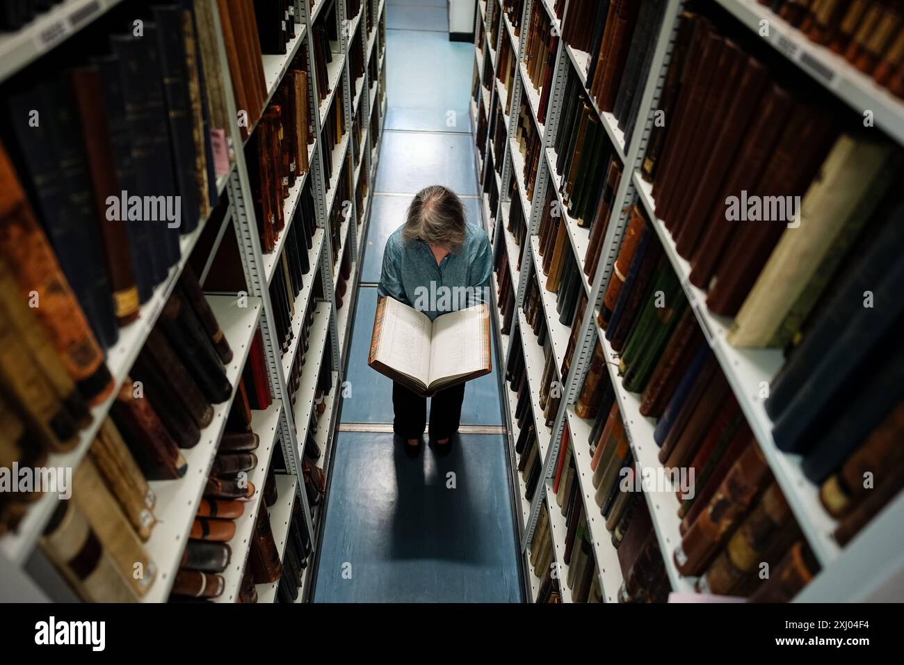 An archivist holds a book in an archive room at the London Metropolitan Archives in London. The ...