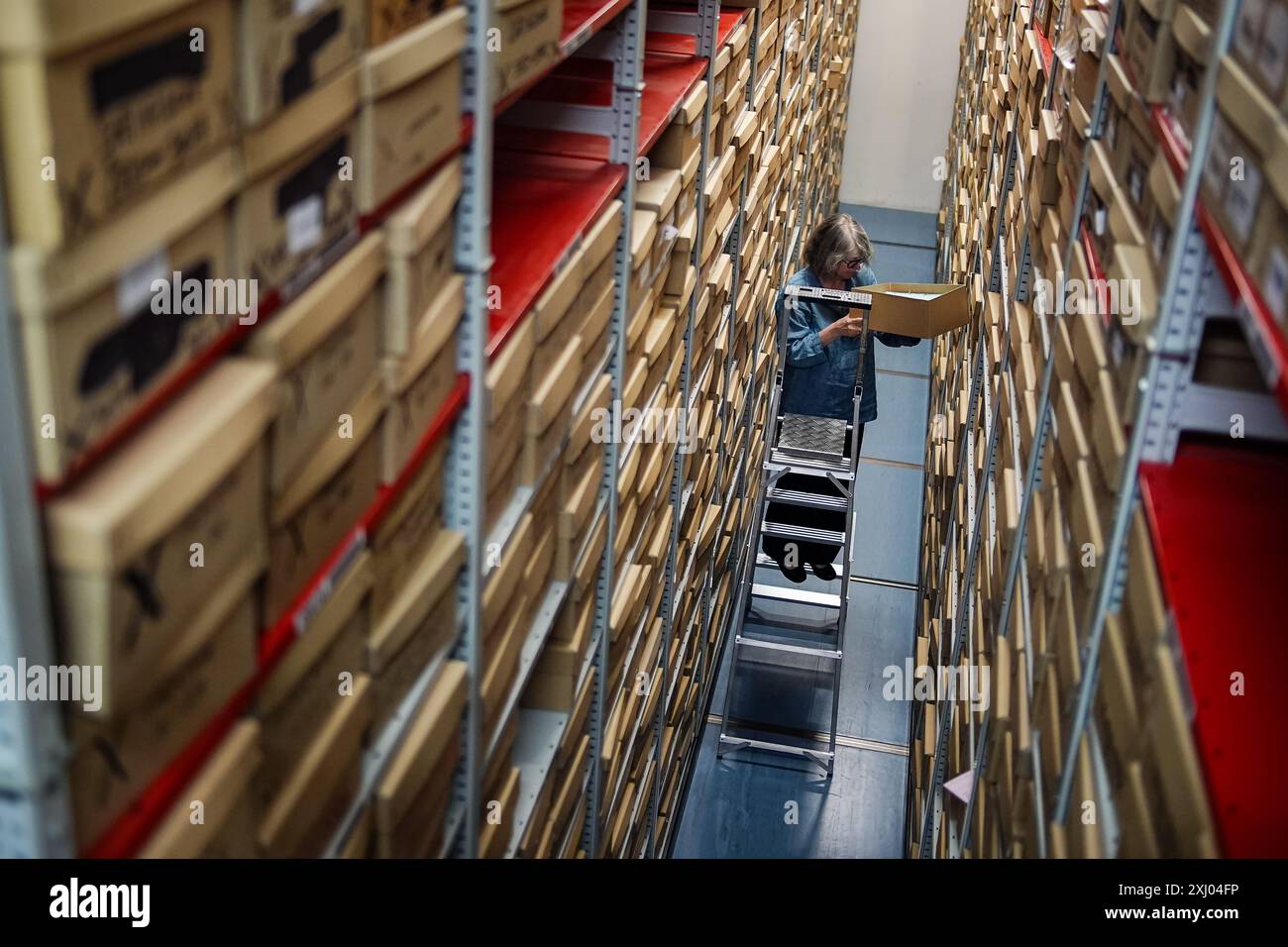 An archivist holds a box in an archive room at the London Metropolitan ...