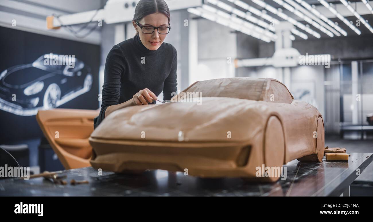 Portrait of a Female Automotive Designer Sculpting a 3D Clay Model of ...