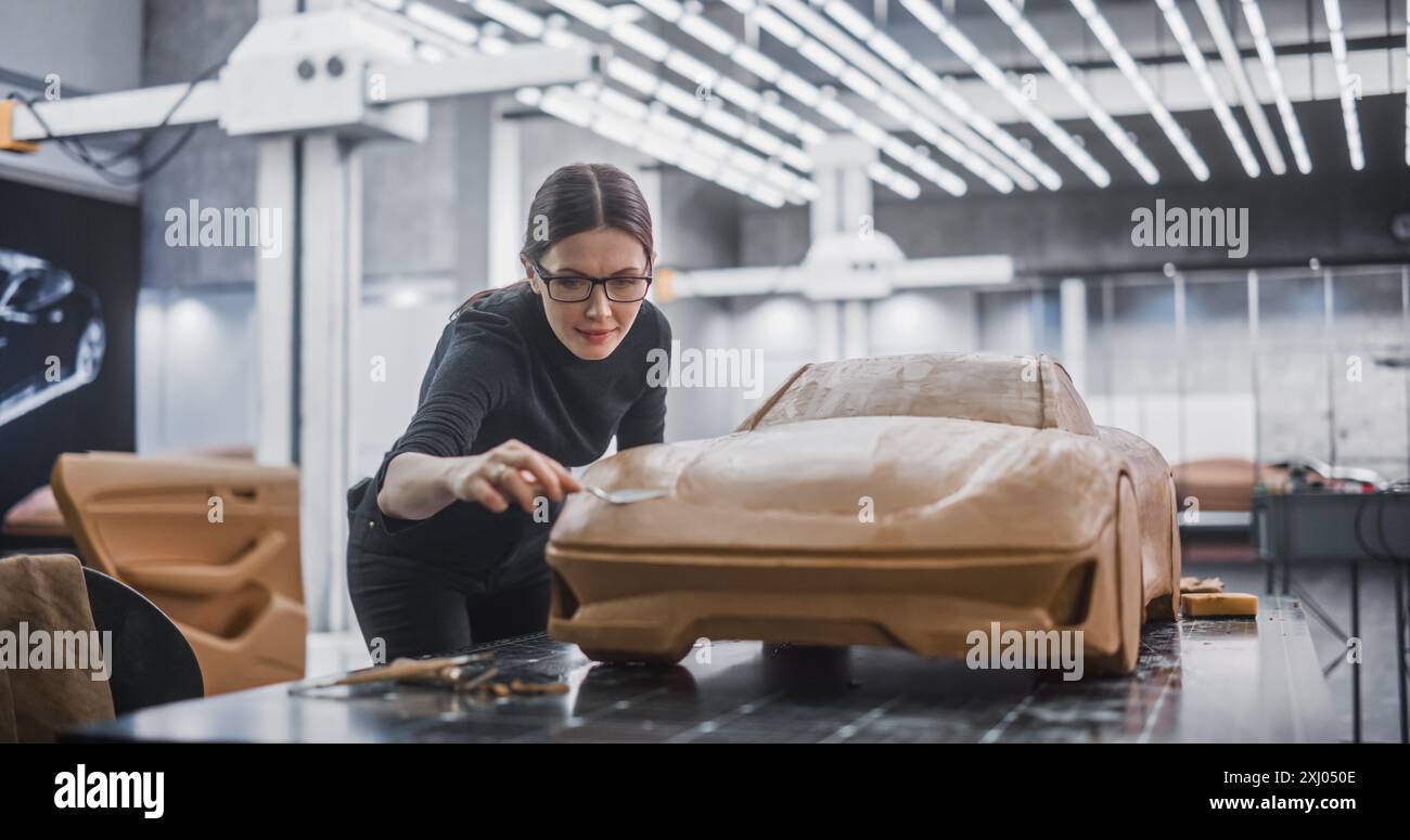 Portrait of a Female Automotive Designer Sculpting a 3D Clay Model of ...