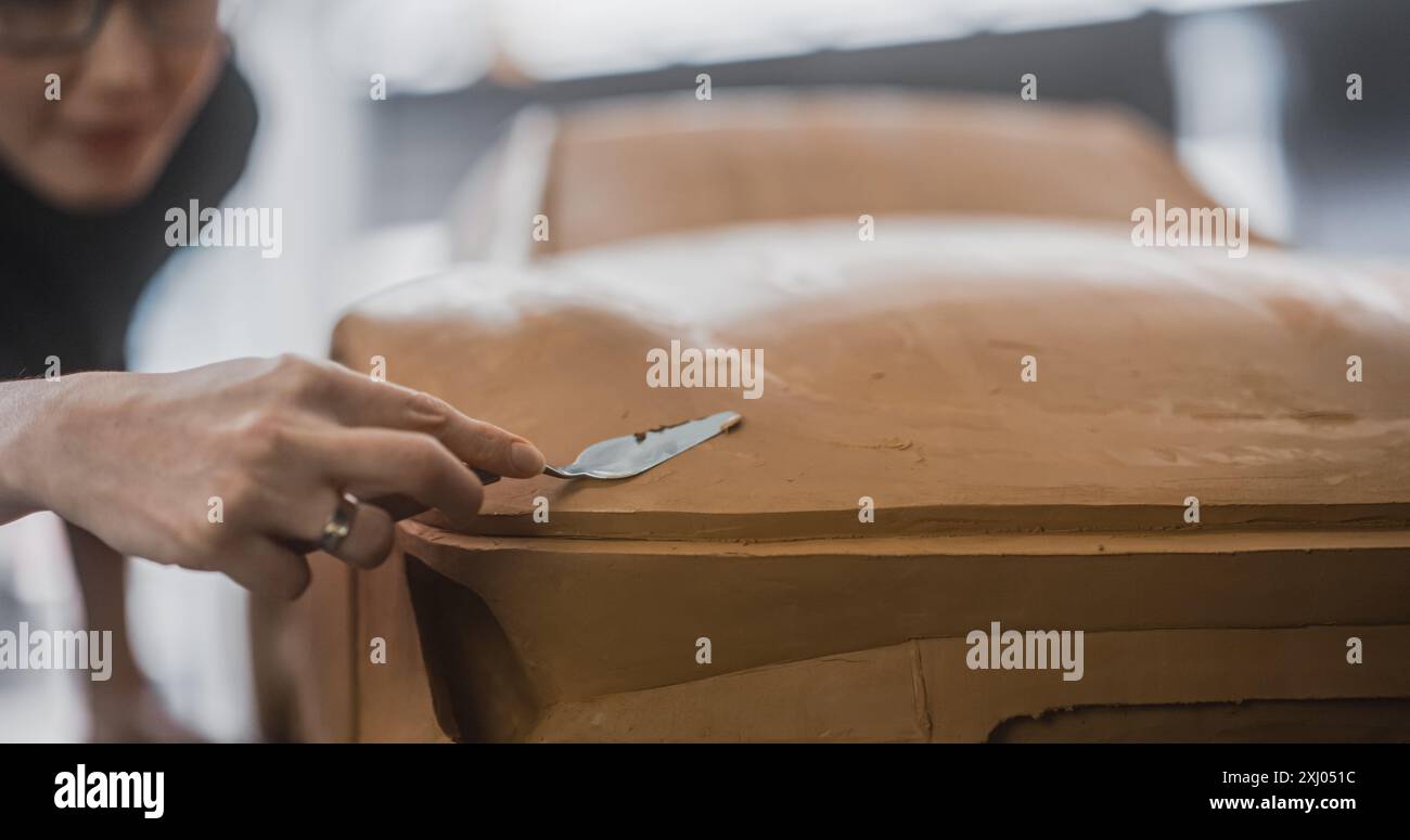 Close Up Portrait of an Automotive Designer Sculpting a 3D Clay Model ...