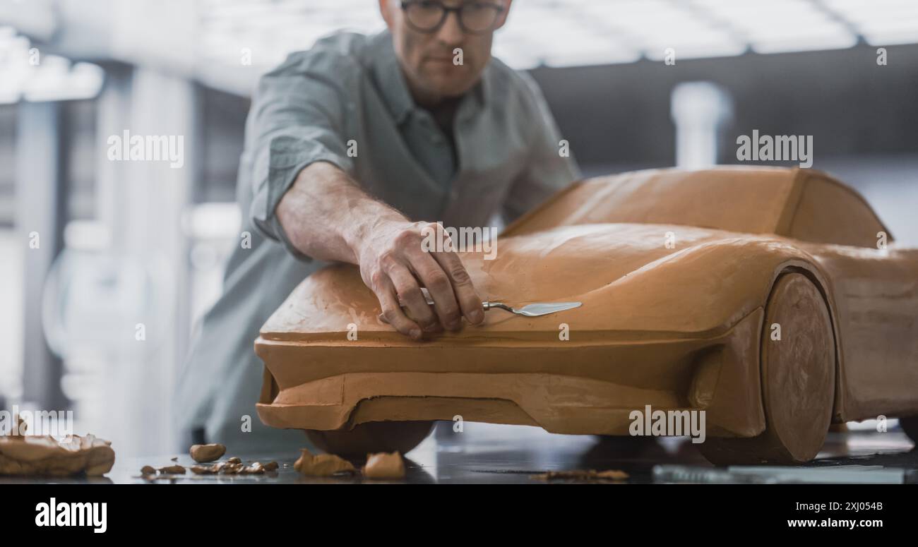 Close Up Portrait of an Automotive Designer Sculpting a 3D Clay Model ...