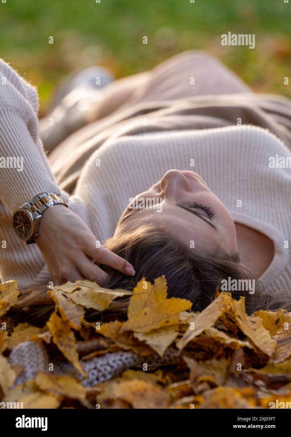 Autumn Walk. Female portrait. A happy girl lies with her eyes closed on ...