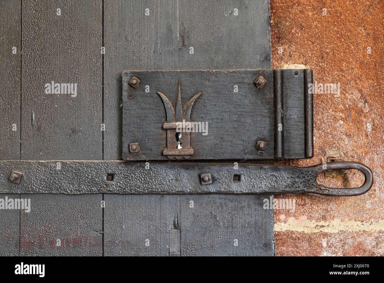 old wooden door with an antique handle and keyhole in an ancient ...