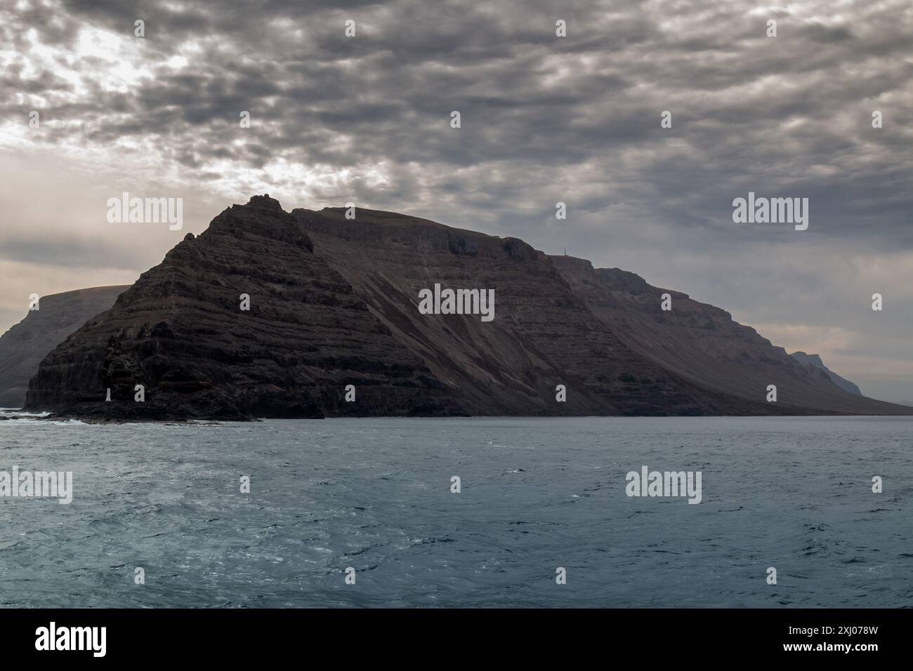 View from a boat on the volcanic cliffs and rocks in the north of the ...