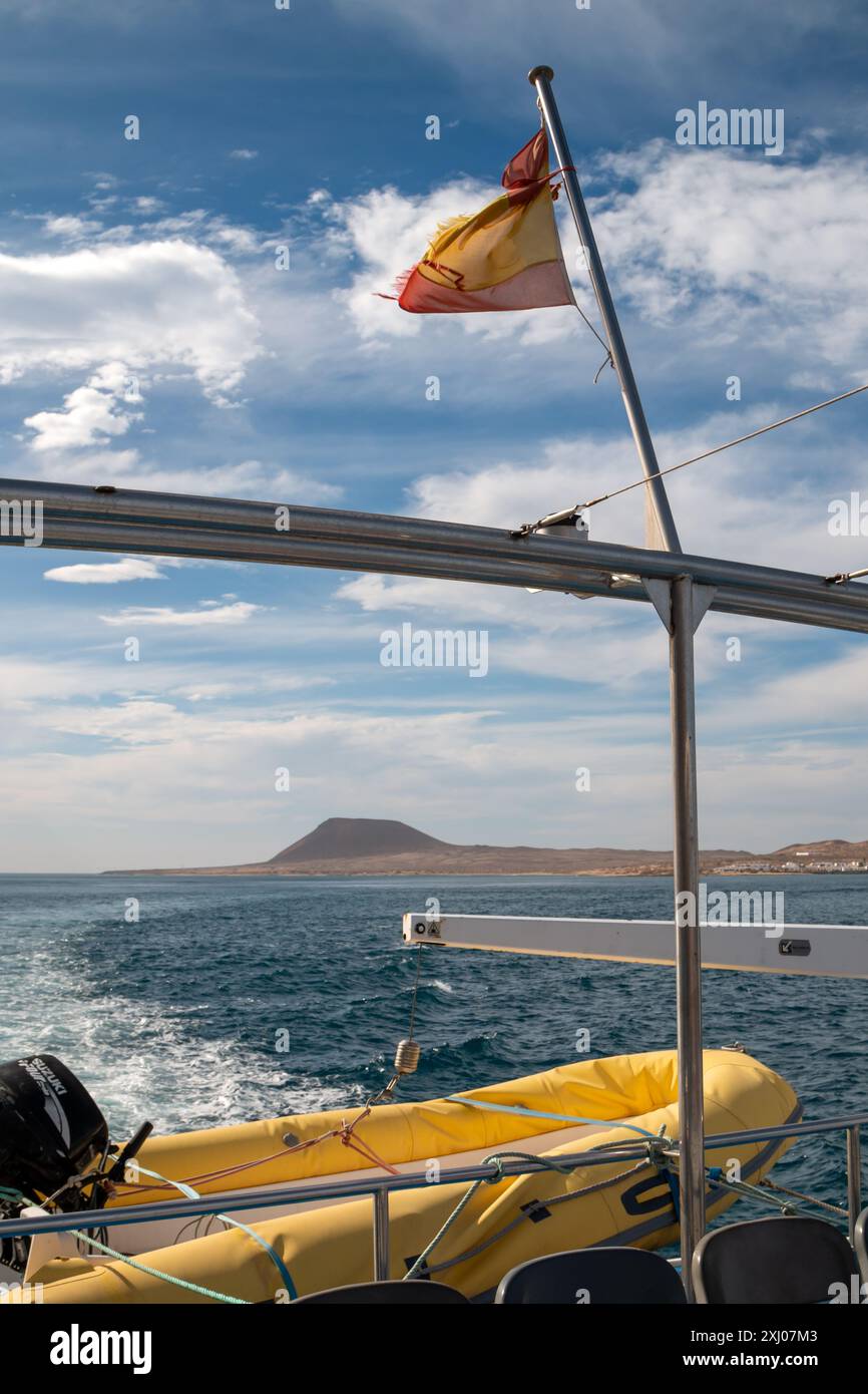 Pole with a rugged spanish flag. Damaged from a wind on a boat between ...
