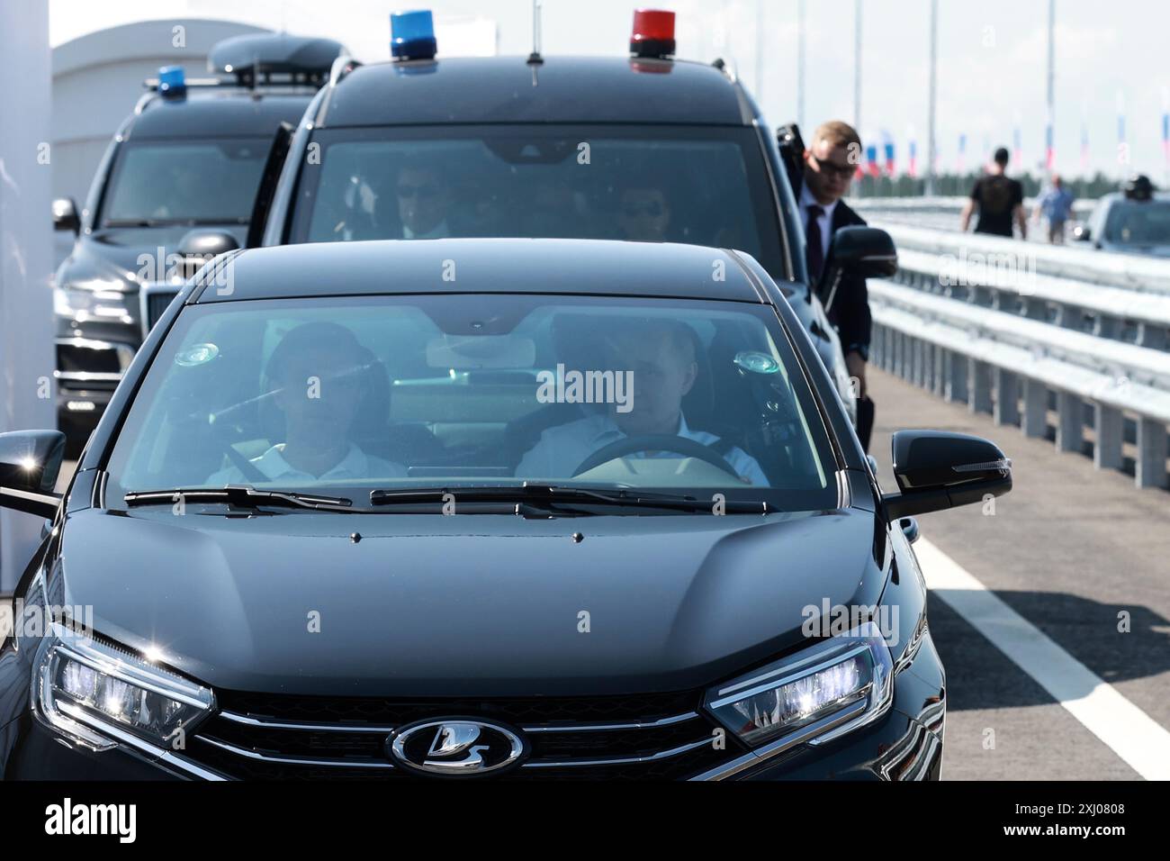 Russian President Vladimir Putin, right, drives a Lada Aura car, front ...