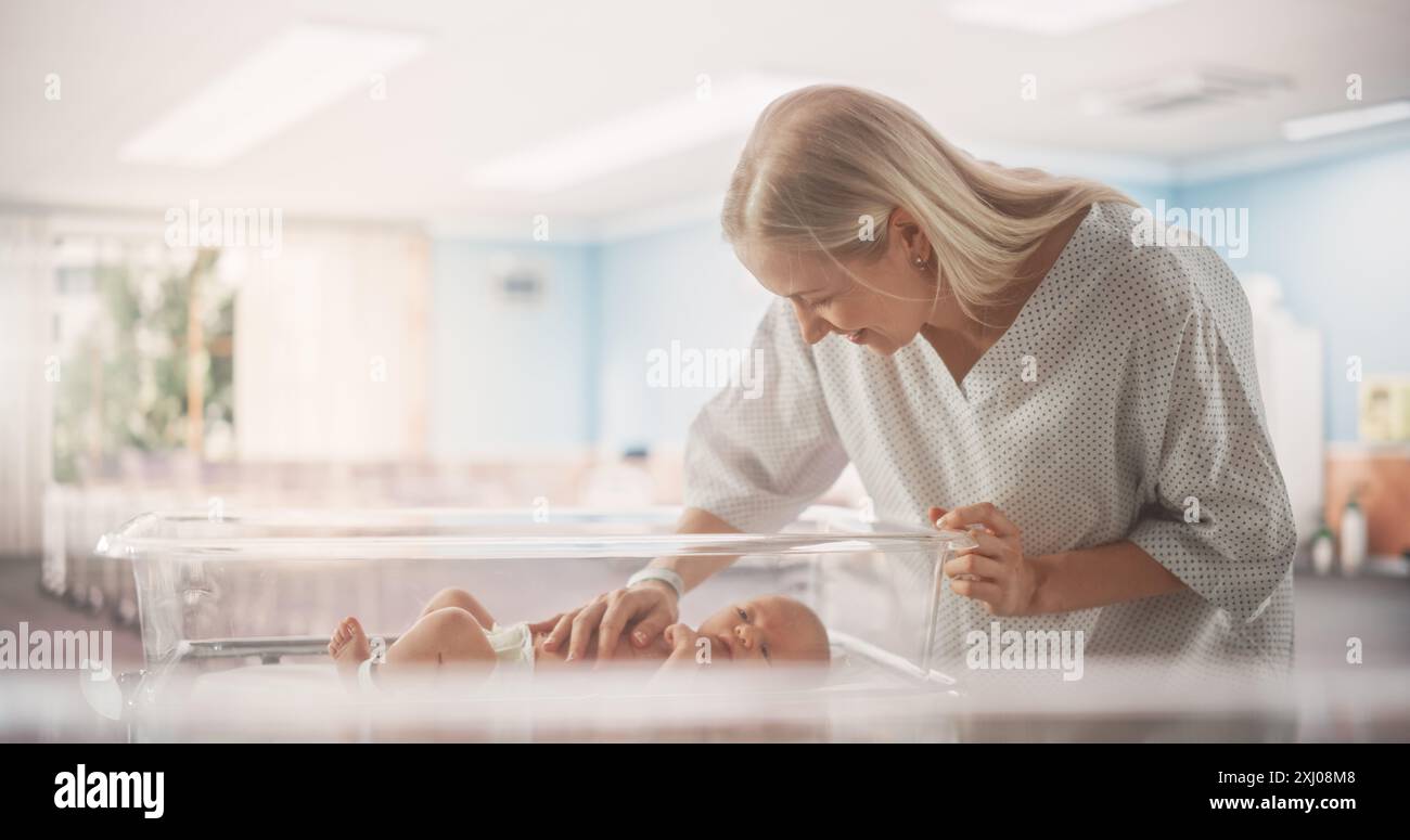 Beautiful Mother Checking Up on a Cute Newborn Baby in a Maternity ...