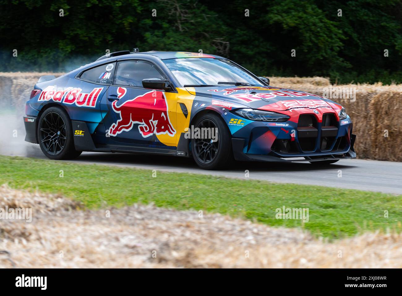 2024 BMW M4 G82 drift car driving up the hill climb track at the Goodwood Festival of Speed 2024 ...