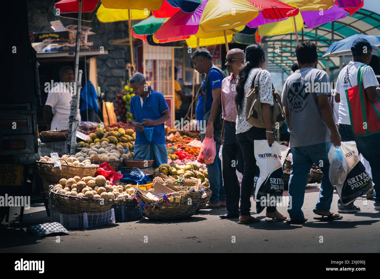 Merchant selling his vegetables and fruit at street market in Kandy ...