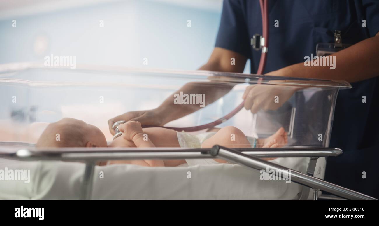 Maternity Hospital Ward: Friendly Black Head Nurse Uses Stethoscope to ...
