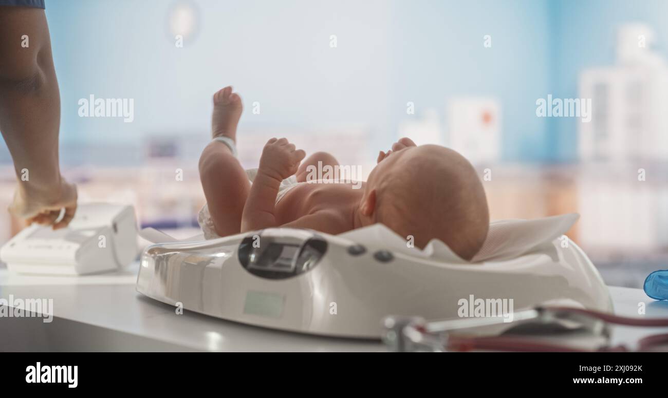 Newborn Infant Lying on Modern Digital Baby Scales in a Maternity ...