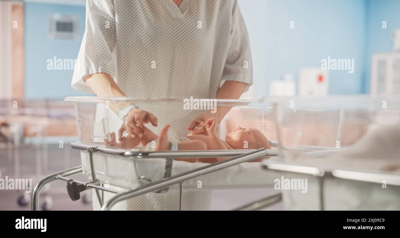 Beautiful Mother Checking Up on a Cute Newborn Baby in a Maternity ...