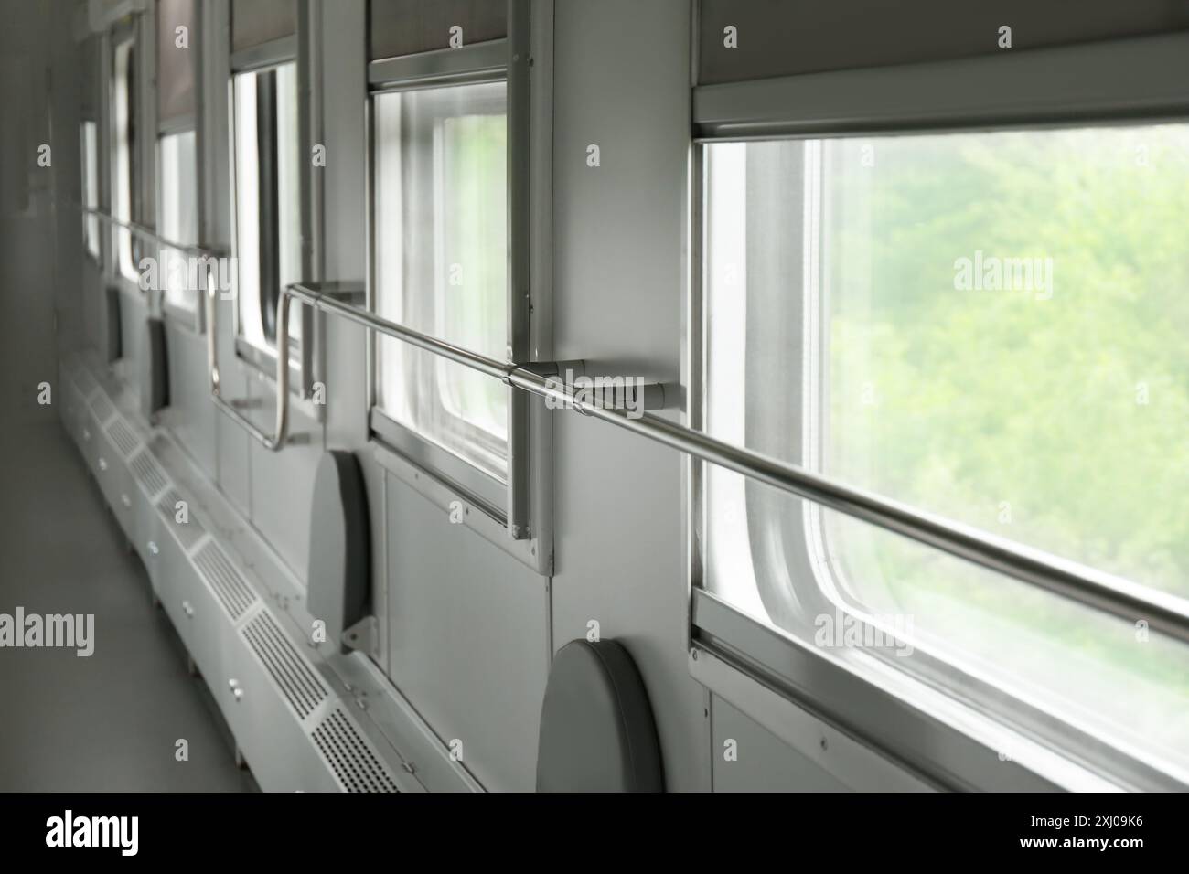 Windows and metal handrails in train car Stock Photo - Alamy