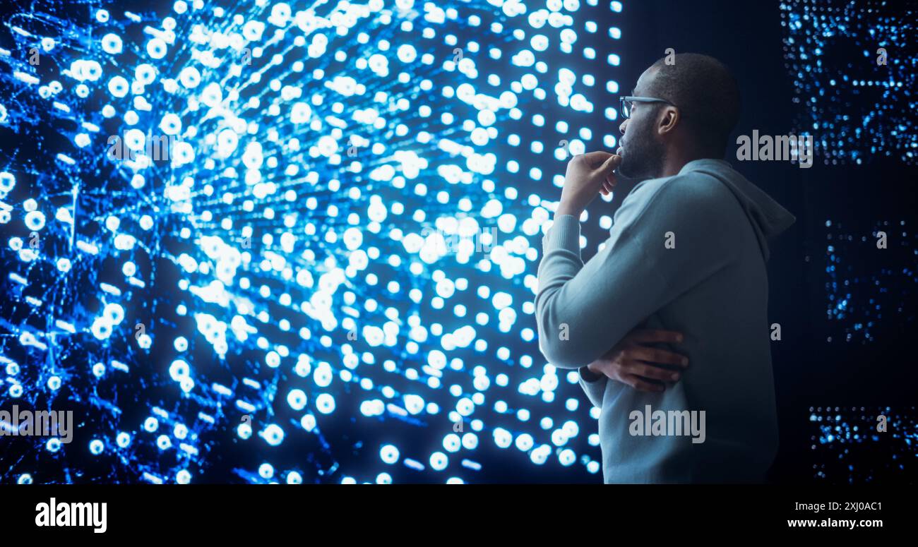 Black Young Man Looking at a Big Screen with Neural Network ...