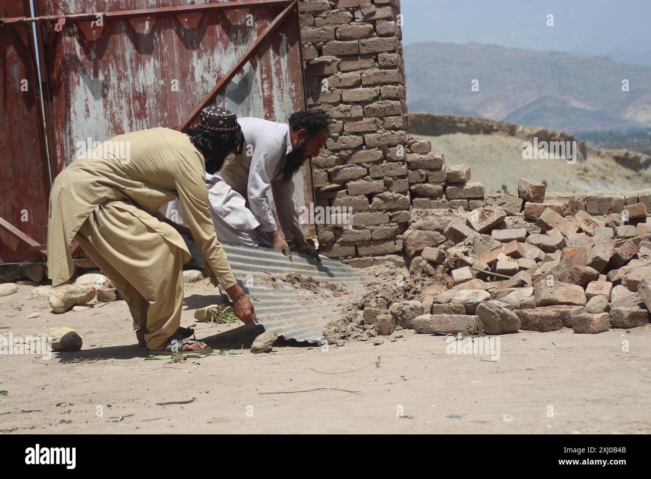 Nangarhar, Afghanistan. 15th July, 2024. Residents clear off the ruins ...