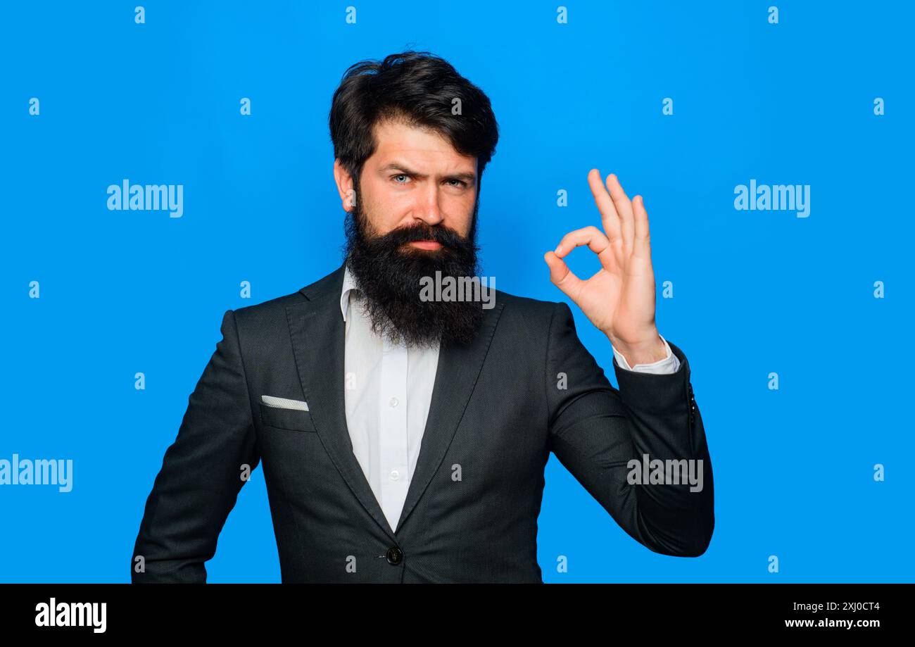OK sign. Handsome businessman showing approval sign. Serious bearded ...