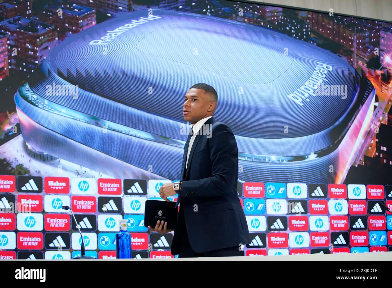 Kylian Mbappe, of France, leaves at the end of a news conference after ...