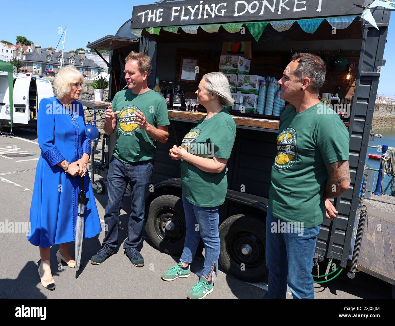 Queen Camilla speaks with employees of The Flying Donkey while touring ...