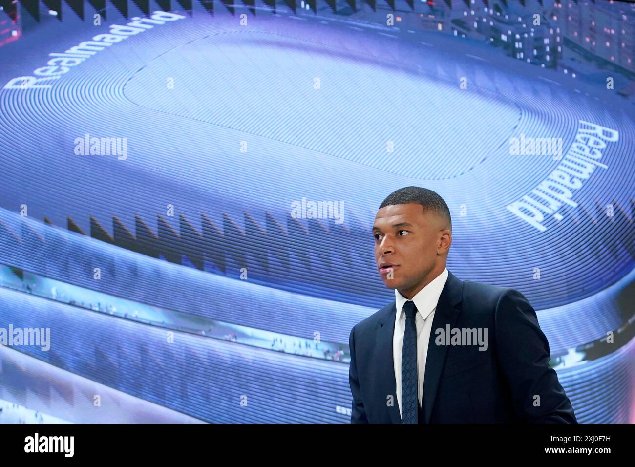 Kylian Mbappe, of France, leaves at the end of a news conference after ...