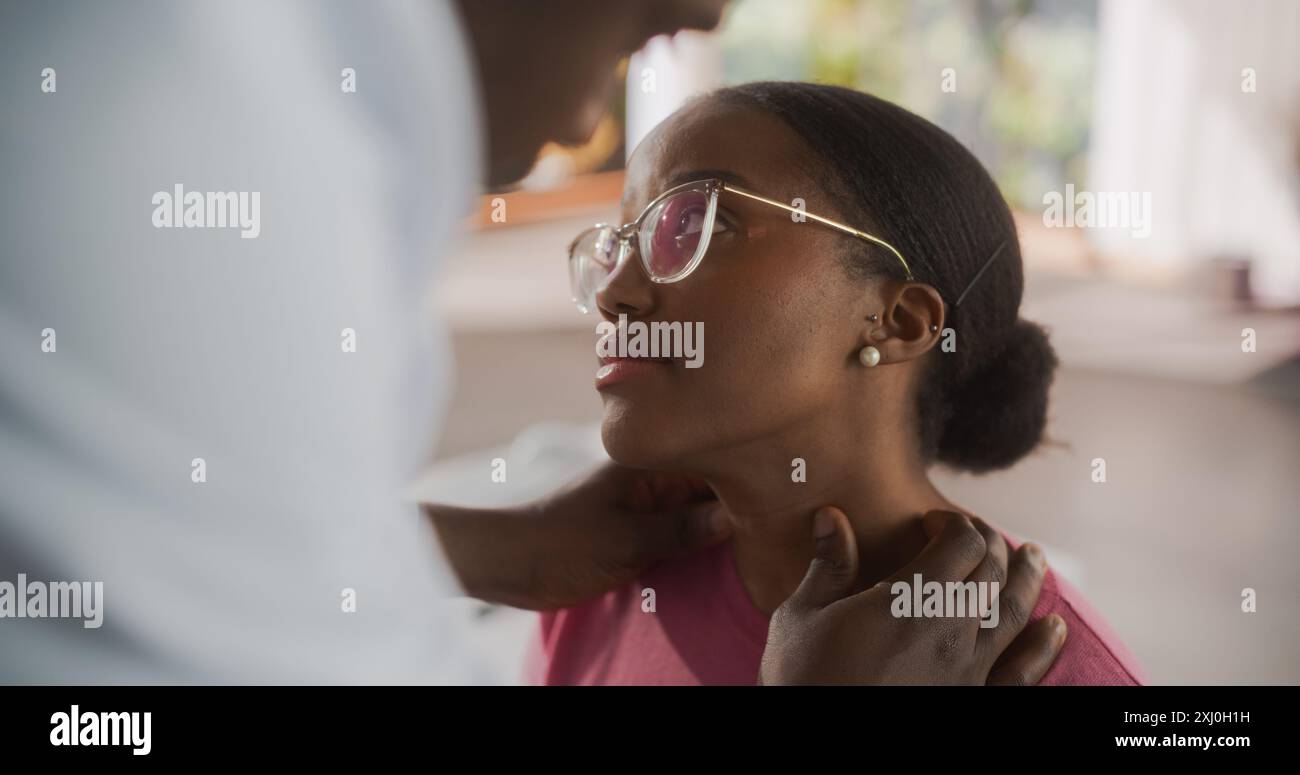 Black Physician Inspect Neck Muscles For Any Damages of a Female ...