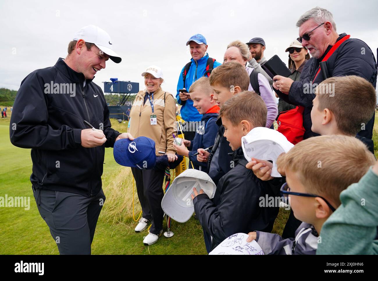 Scotland's Robert MacIntyre signs a Shinty ball for a fan ahead of The ...