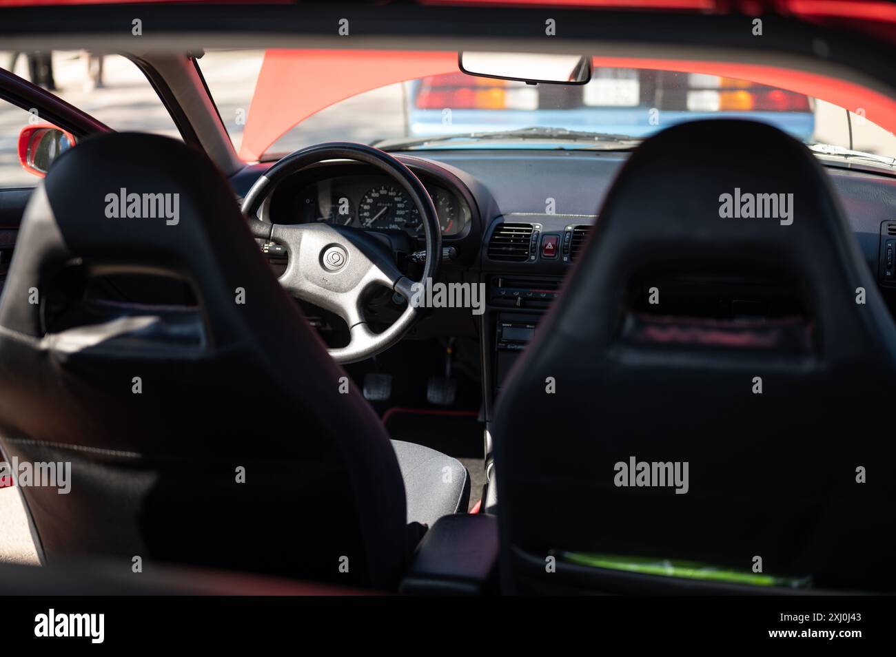 An interior view of a car with focus on the steering wheel and ...