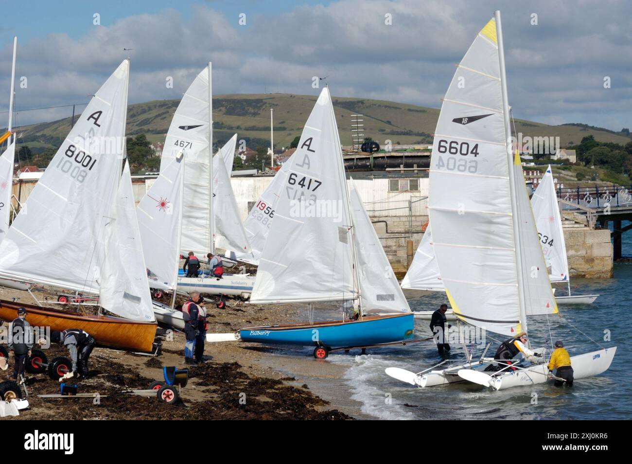 Launching Boats and Catamaran on Swanage Bay Dorset England uk Stock ...