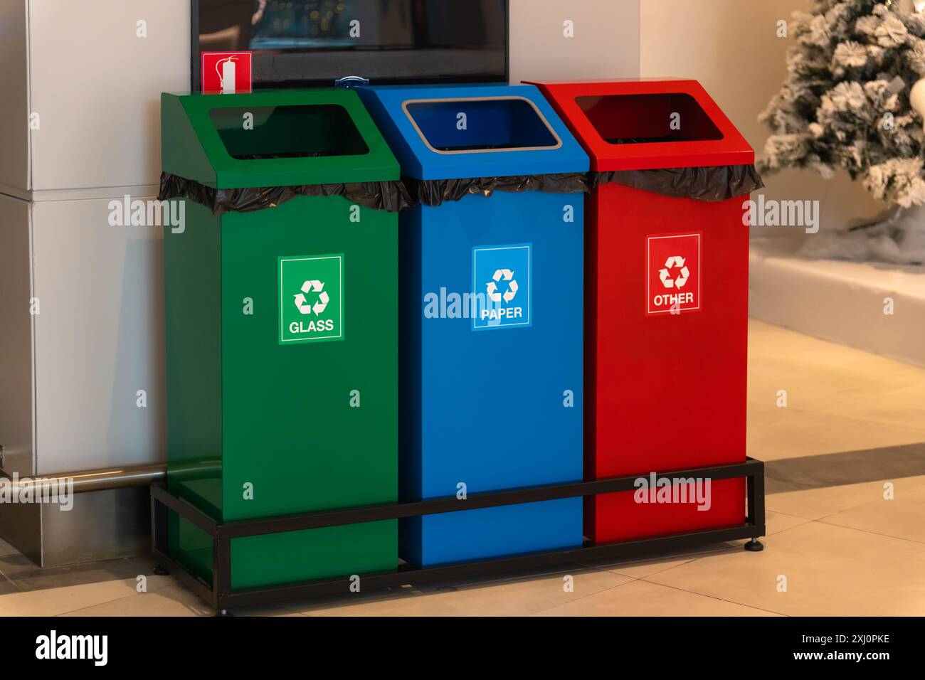 Close-up of green, blue, and red trash cans for separate dumping of ...