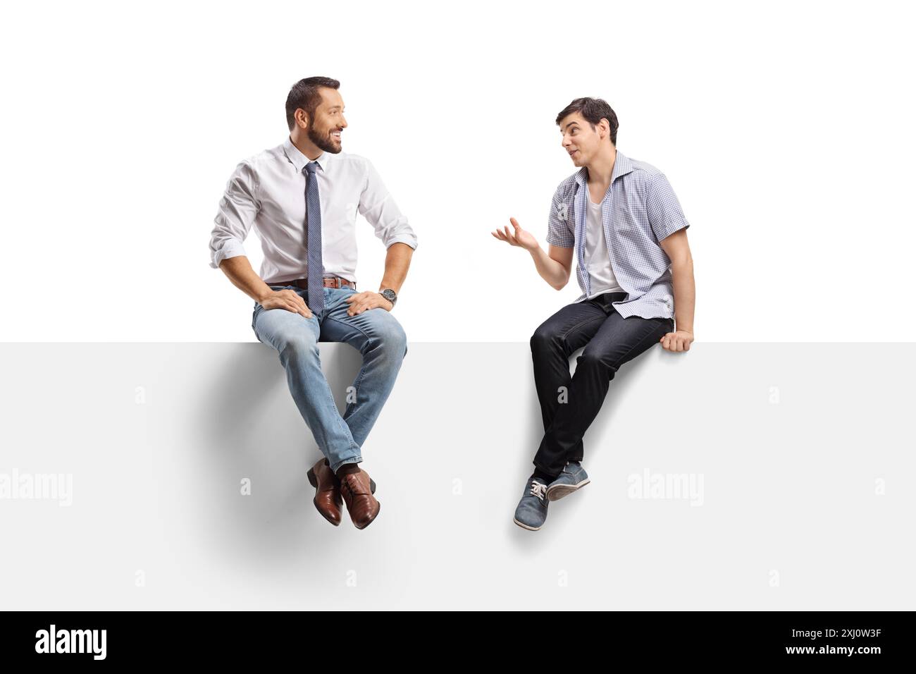 Two young men sitting on a panel and discussing isolated on white ...