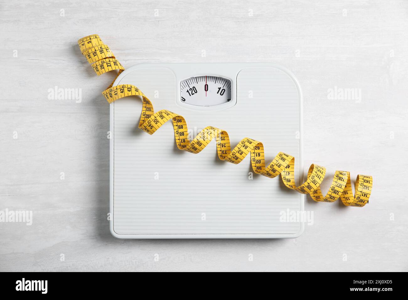 Scale and measuring tape on white wooden background, flat lay Stock ...