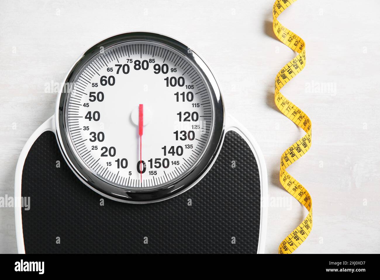 Scale and measuring tape on white wooden background, flat lay Stock ...