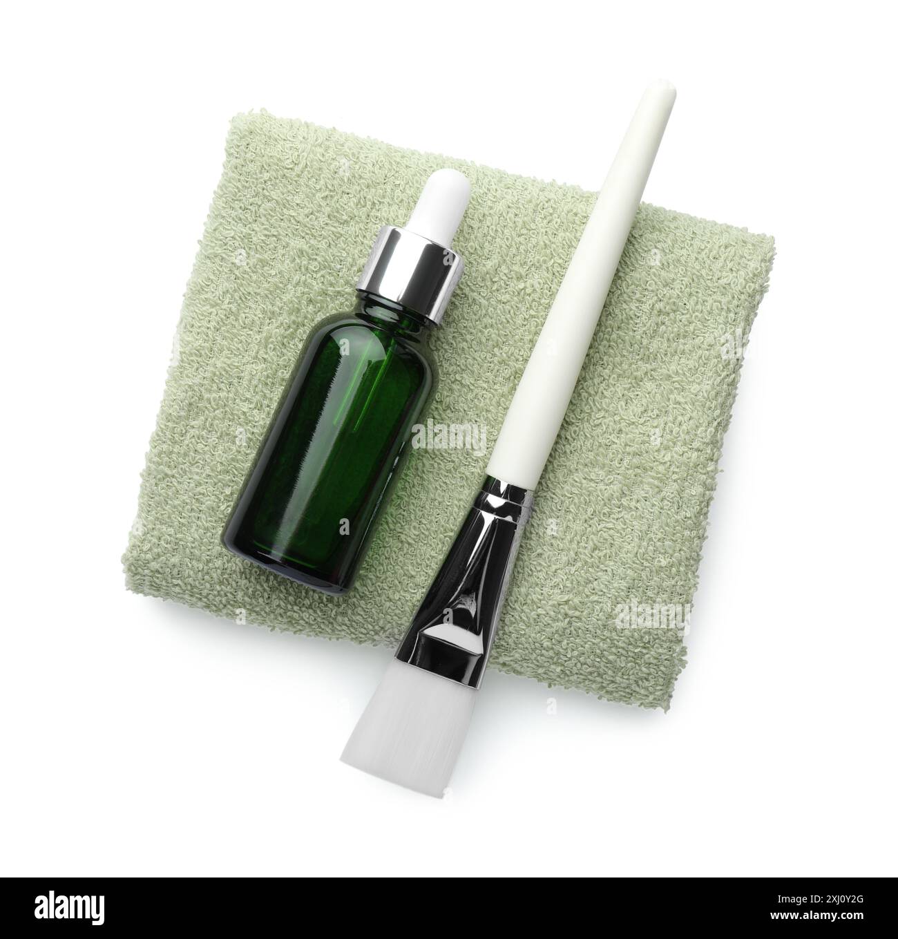 Bottle of chemical peel, brush and soft towel isolated on white, top ...
