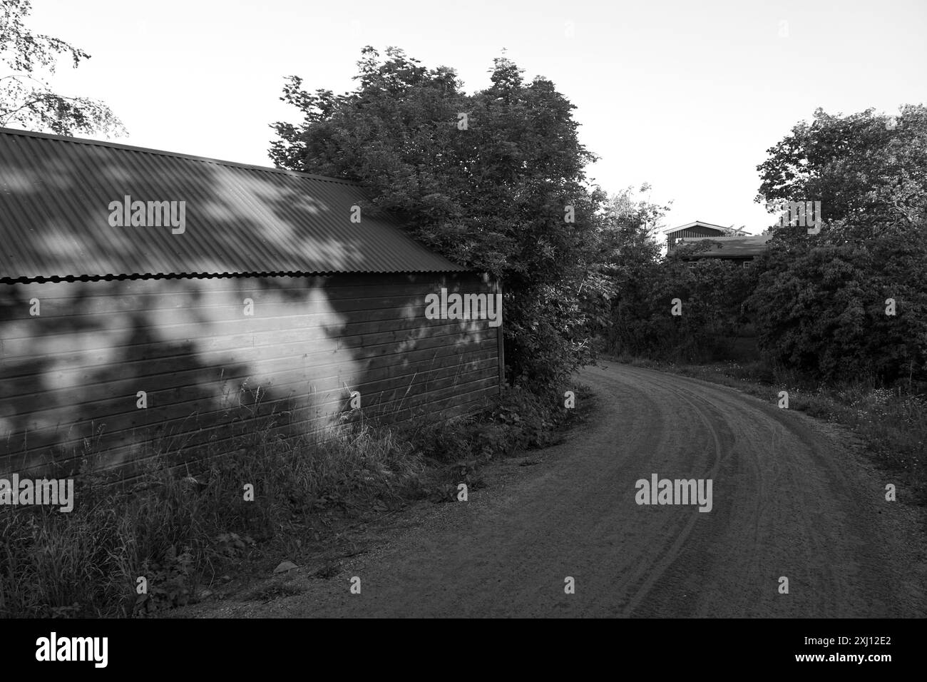 A dirt road next to building Stock Photo - Alamy