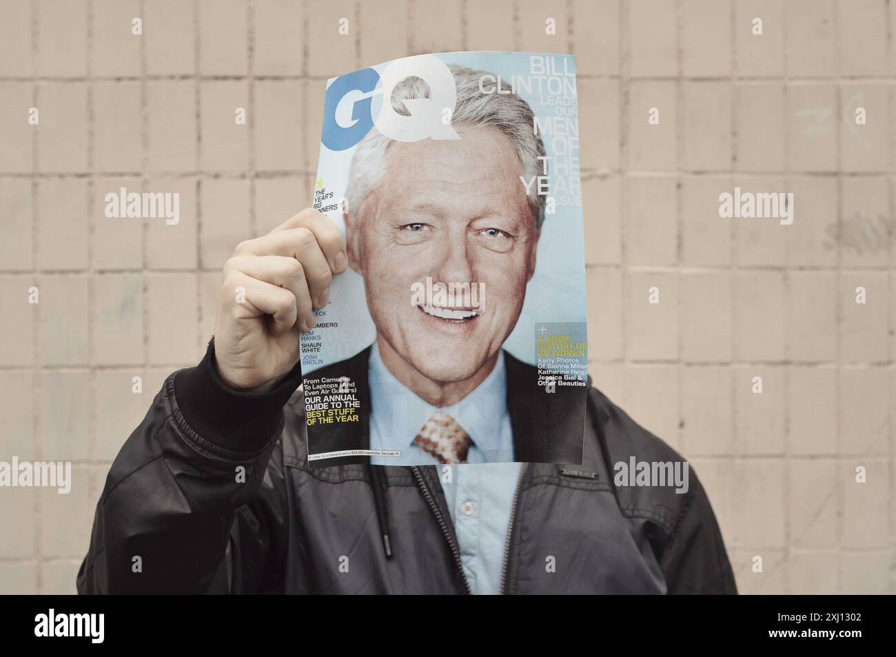 Fake identity: Bill Clinton. Person holding a magazine with a portrait ...