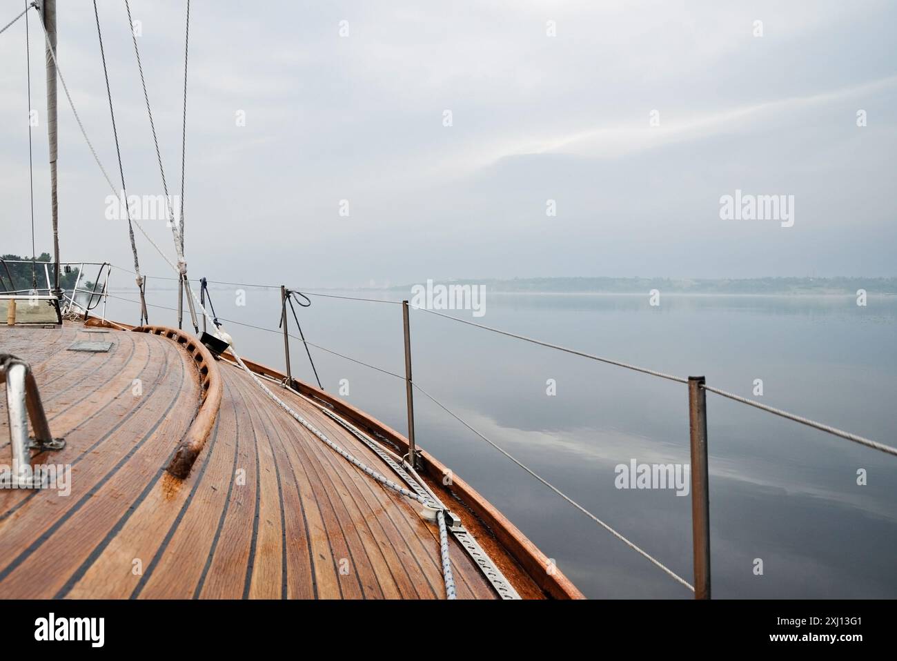 Sailing in a lake in cloudy weather. Calm water right before the storm ...