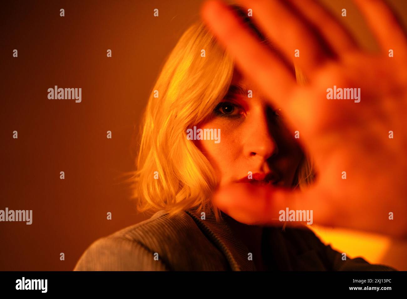 In cinematic lighting, a blonde woman poses elegantly, exuding beauty ...